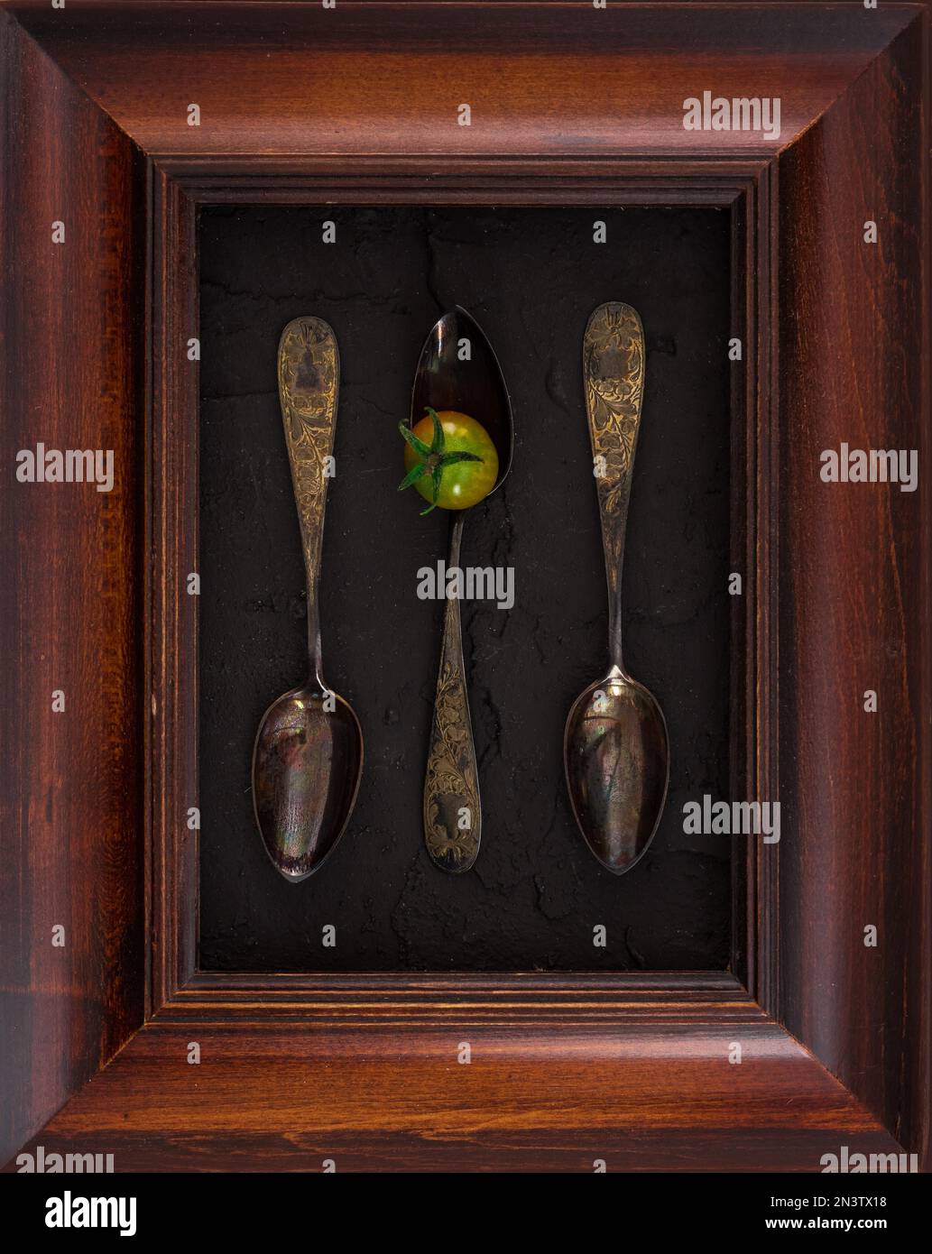Still Life with Old Silver Spoons and Green Tomato in a Wooden Frame ...