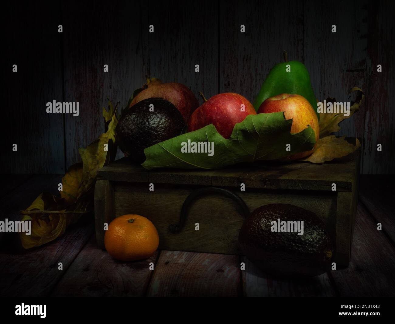 Still Life with Fruit and Leaves on an Old Wooden Box Stock Photo - Alamy