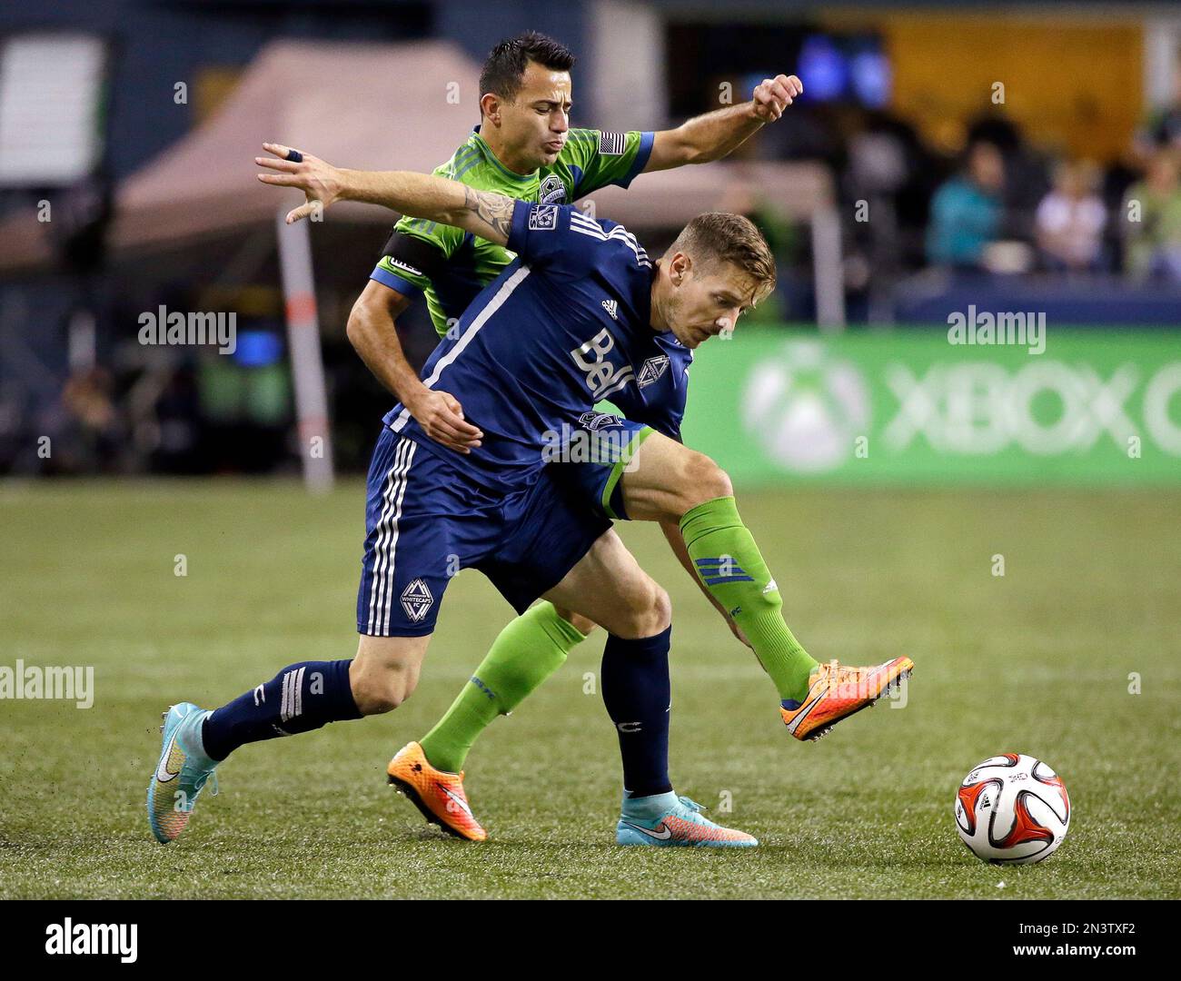 Vancouver Whitecaps' Jordan Harvey, right, and Seattle Sounders' Marco ...