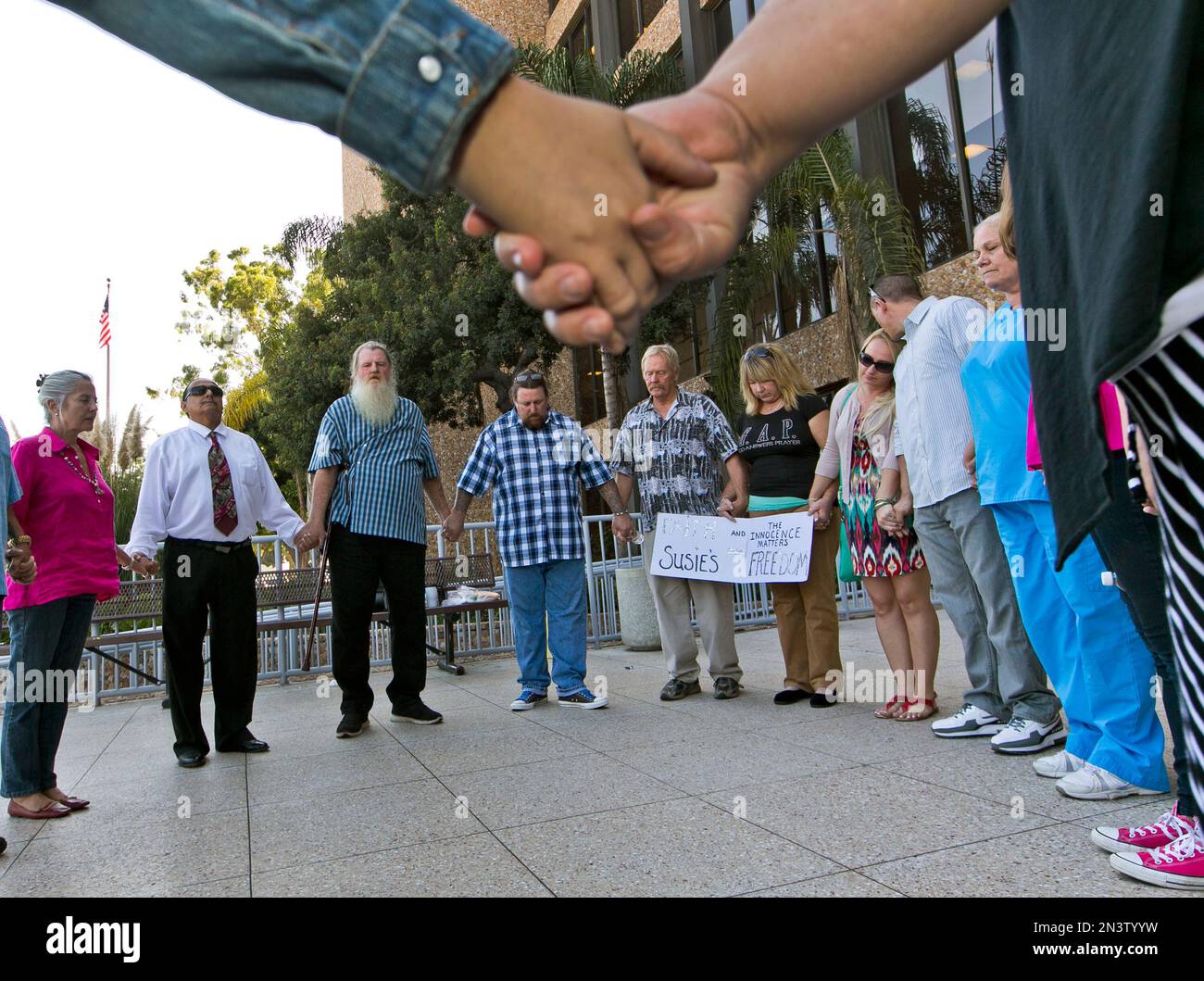 Family members and friends of Susan Mellen hold a praying circle as ...