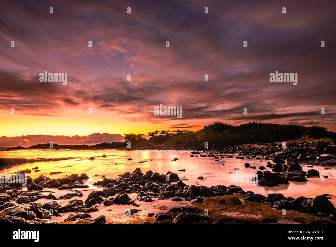 View over a rocky coast into the sunset, Mauritius Stock Photo - Alamy
