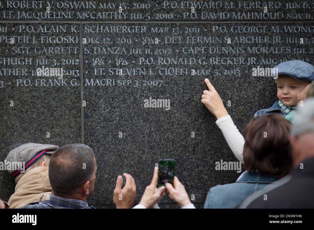Louisa Cioffi, widow of Lt. Steven Cioffi, holds her song as she points ...