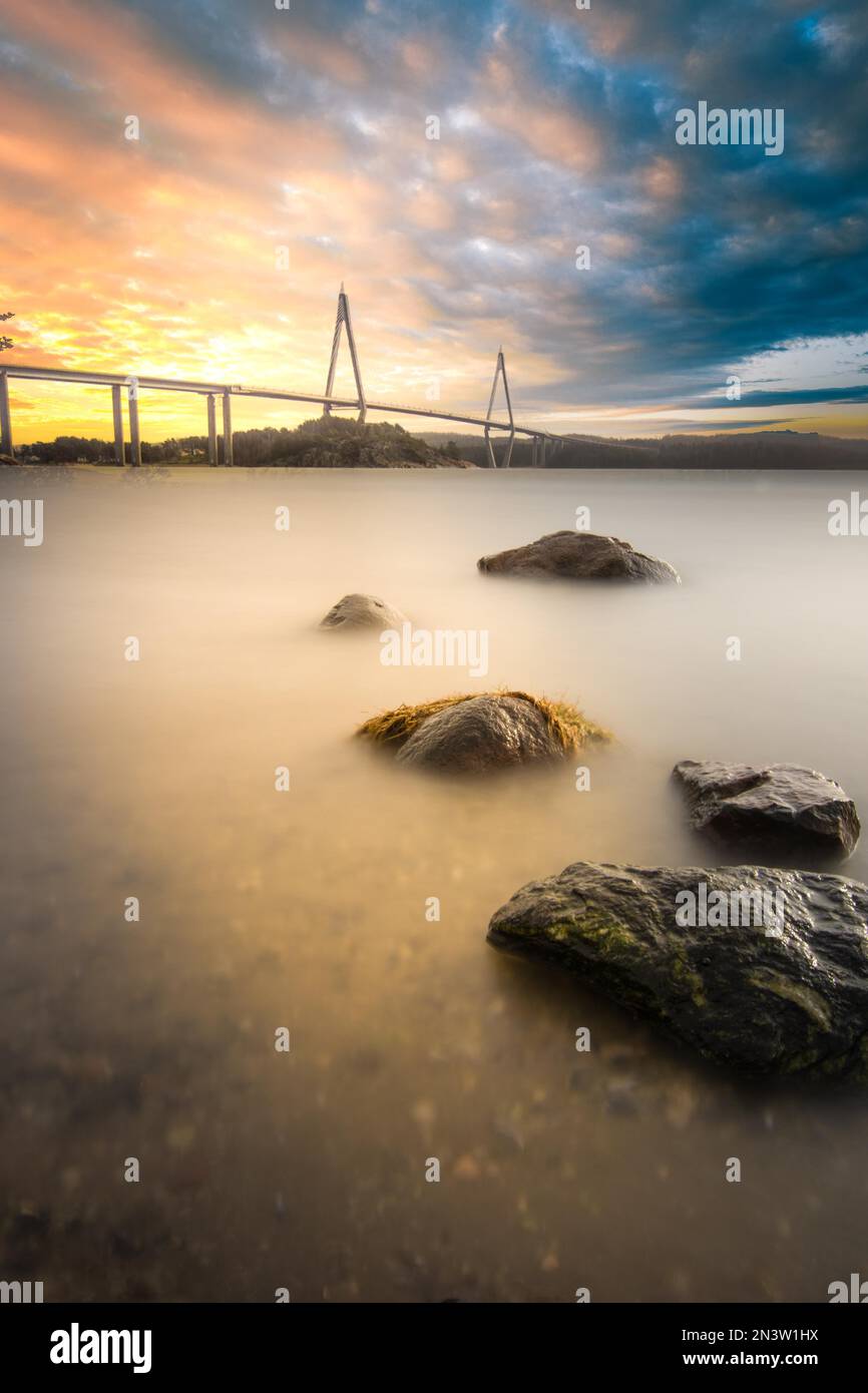 The motorway bridge of Uddevalla, sunset, long exposure over a fjord ...