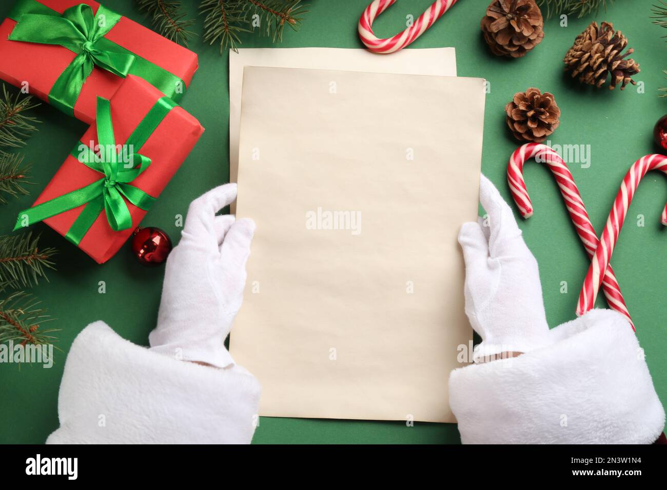 Santa holding letter at green table, top view Stock Photo - Alamy