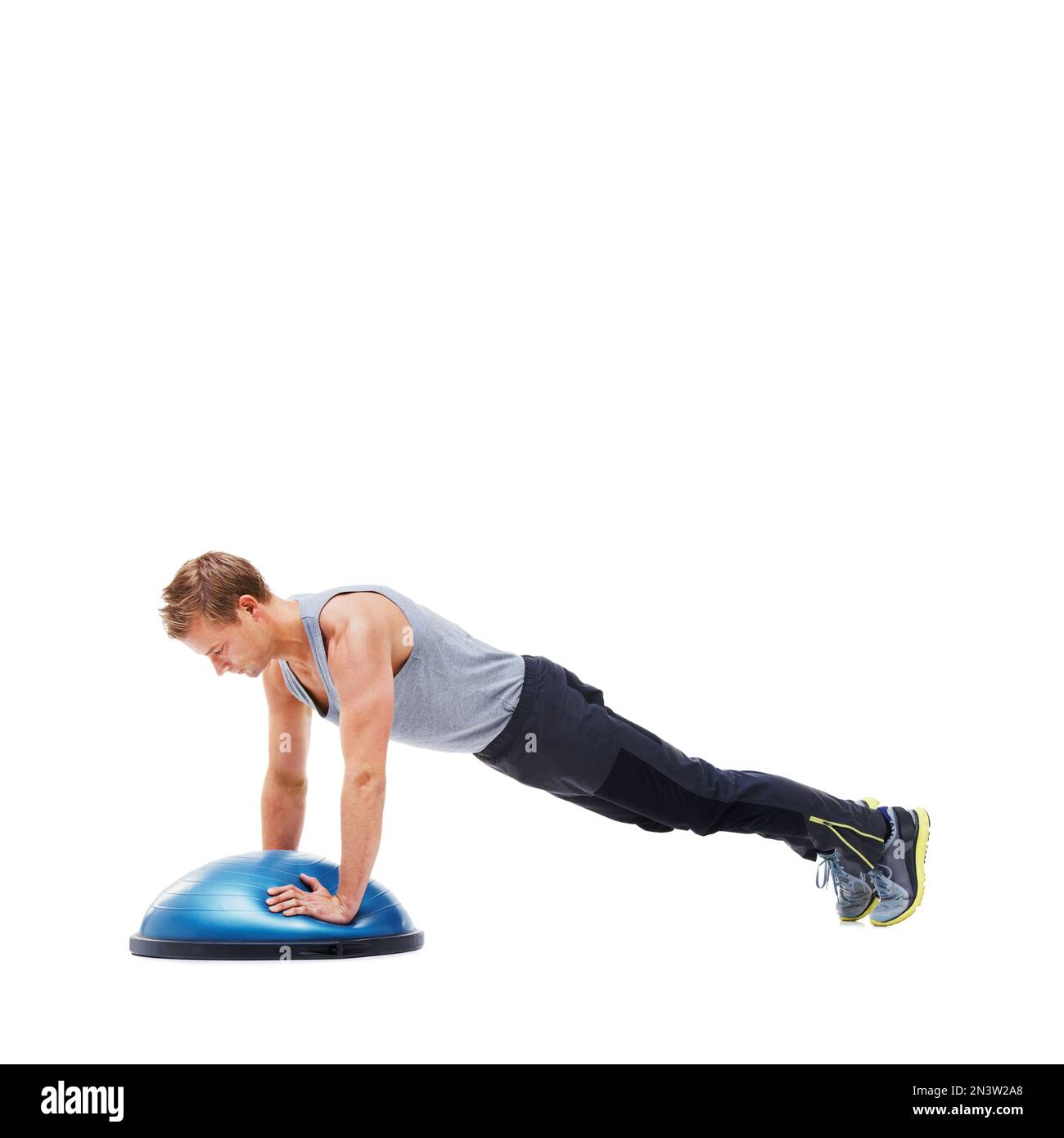 His workout plan is simple yet effective. A young man doing push-ups on ...