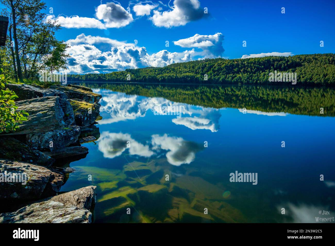 Lake with reflection of forests and clouds, the lake Aerr in the ...