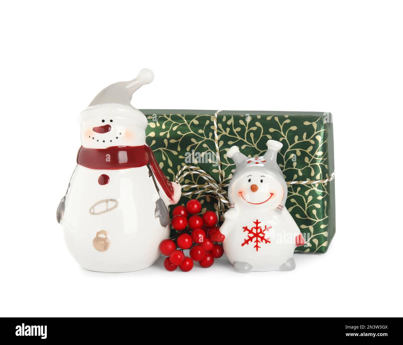 Christmas composition with decorative snowmen and gift box on white ...