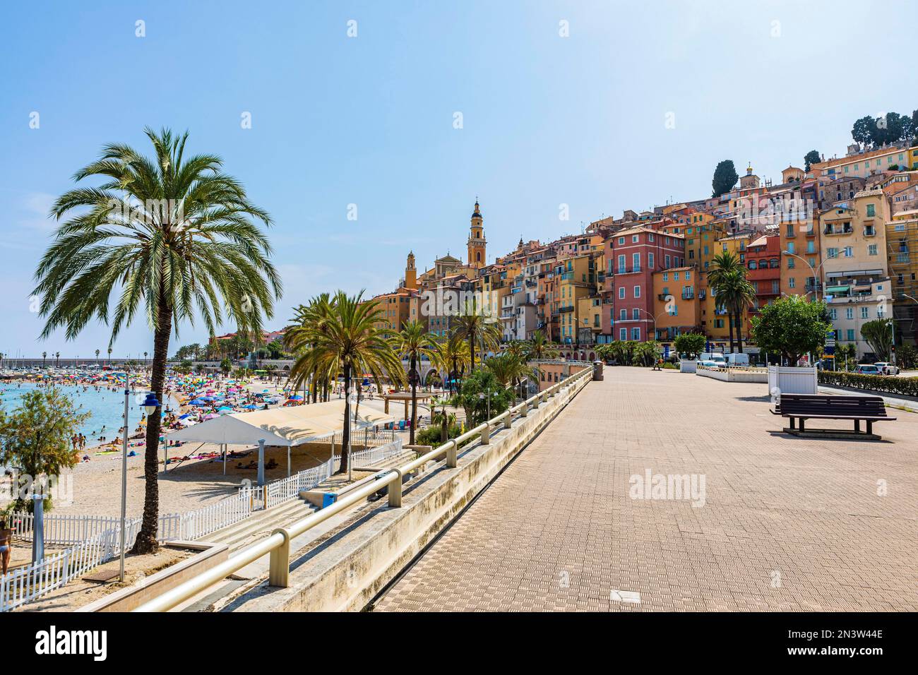 The boulevard of Menton, behind it the colourful house facades and the ...