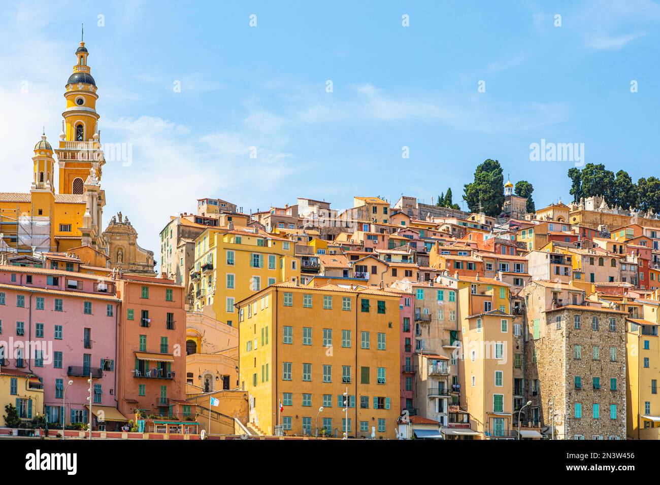 Colourful house facades of Menton with the Basilica Saint Michael ...
