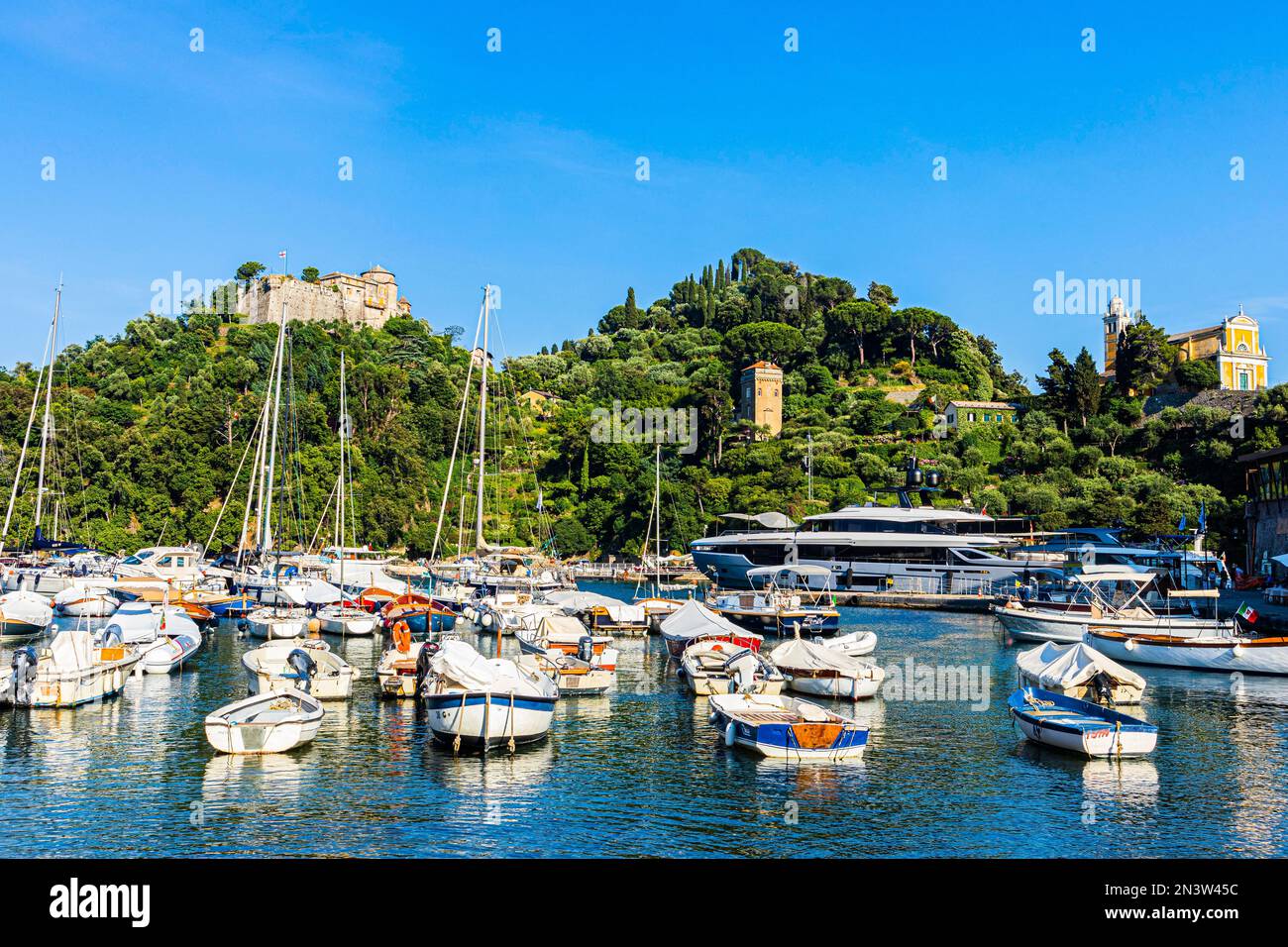 Yachts and boats anchored in the harbour of Portofino, Brown Castle and ...