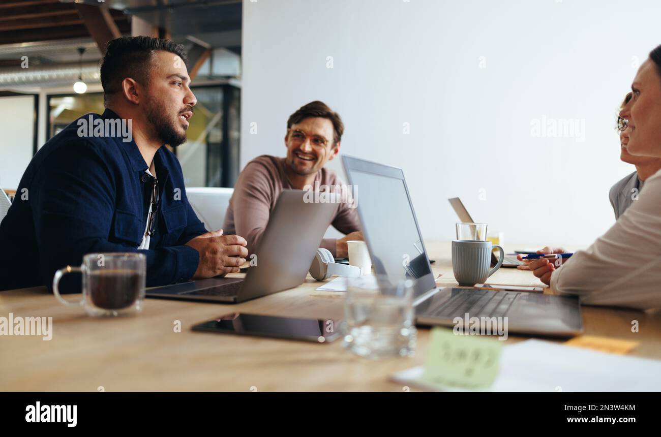 Marketing professionals having a discussion in a meeting. Group of ...