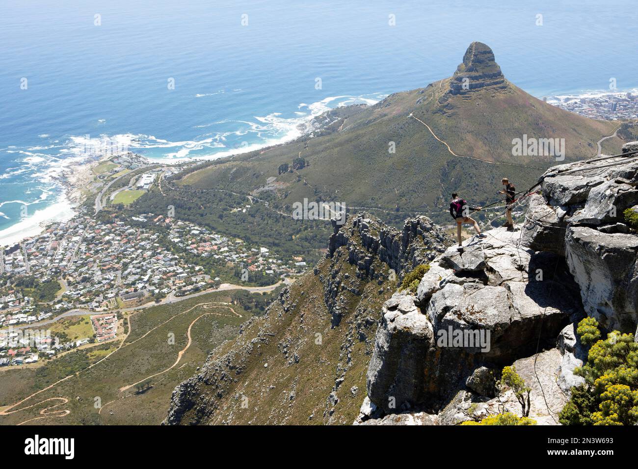 Abseiling on Table Mountain, Lions Head in the back, Camps Bay on the ...