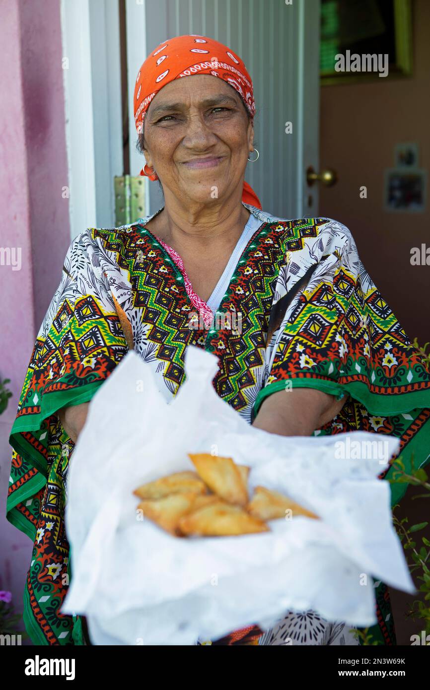 Woman in traditional dress, 68 years, showing Malay dumplings, Bo-Kaap ...
