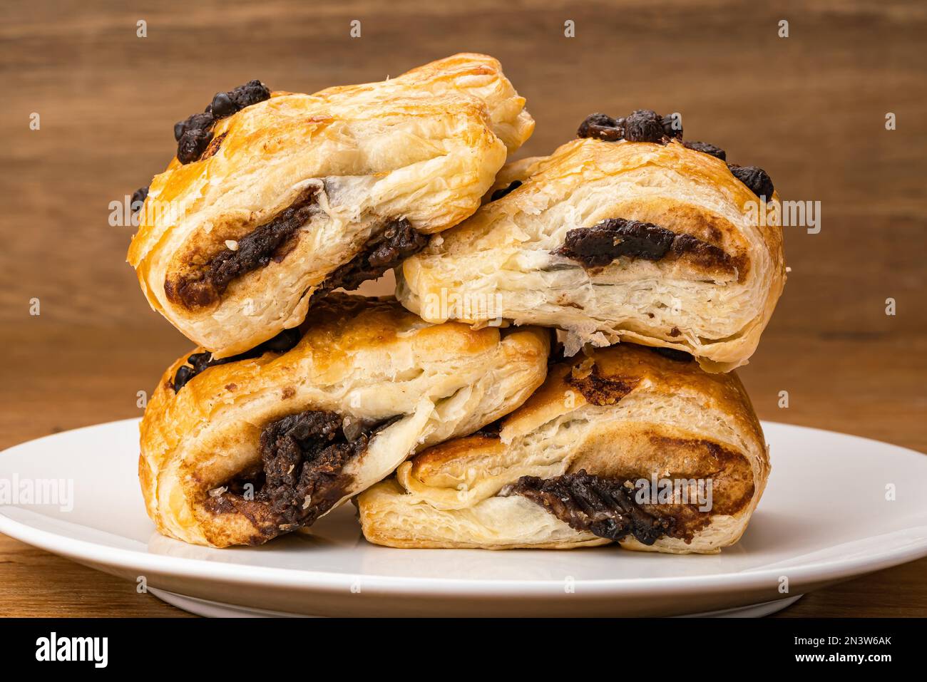 Side view pile of Danish Pastry with chocolate filling topping with ...