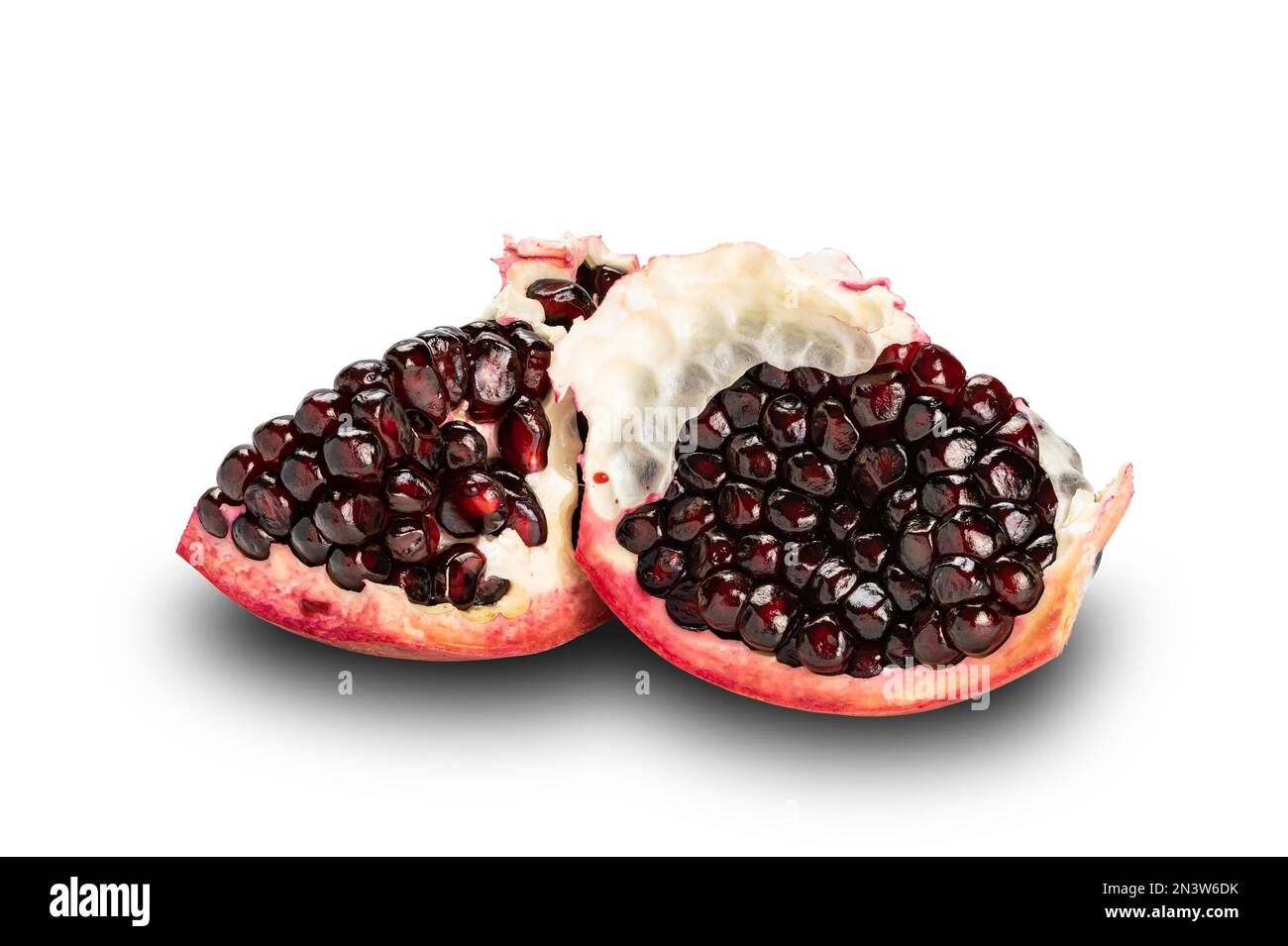 Pieces of dark red pomegranate fruit isolated on white background with ...