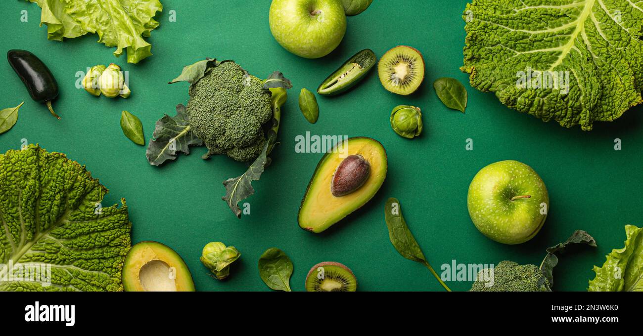 Creative layout healthy organic food concept made of green fruit and vegetables on green ...