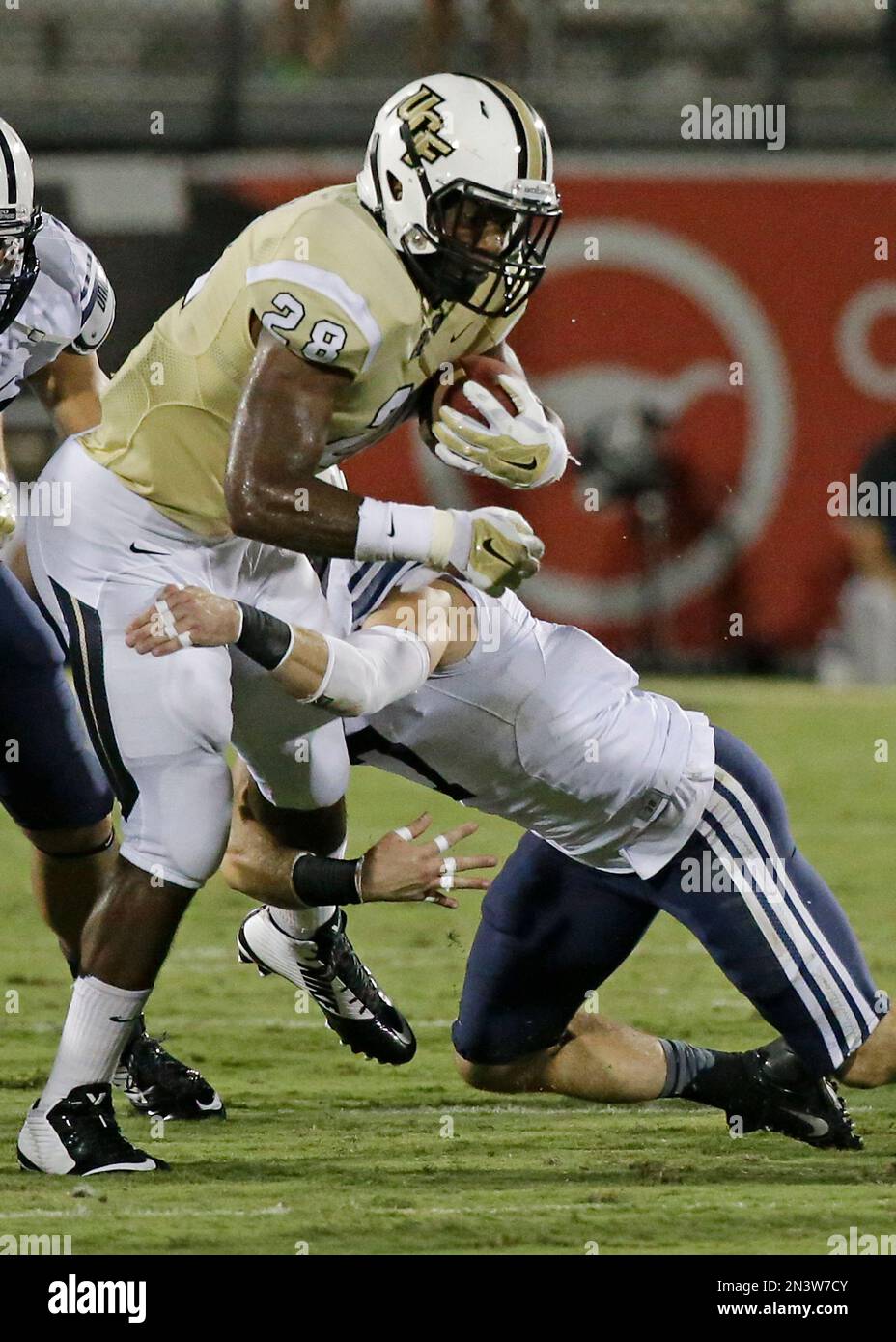 Central Florida running back William Stanback, left, is stopped by ...