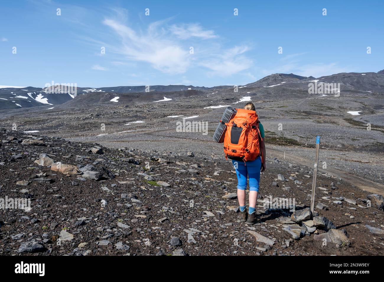 Hiker on the Fimmvoerouhals hiking trail, barren volcanic landscape ...