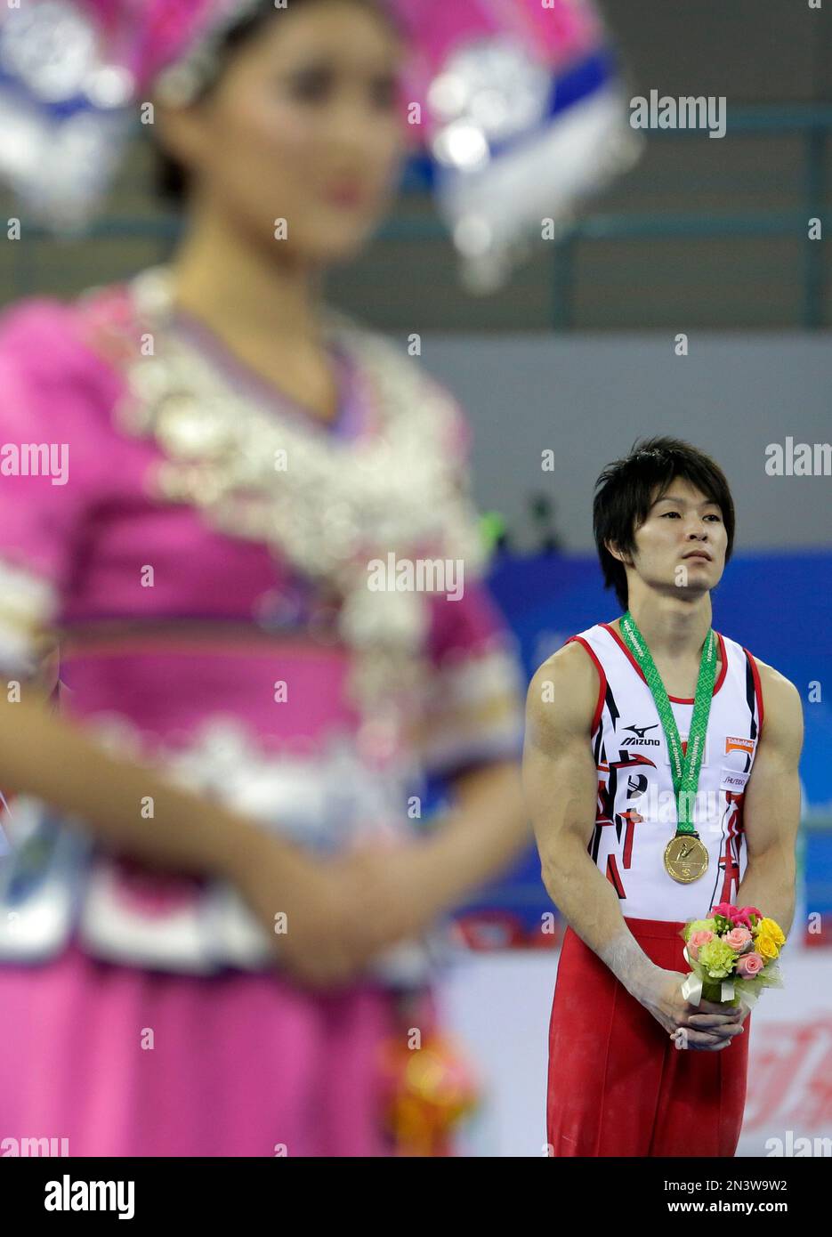 Gold medalist gymnast Japan's Kohei Uchimura stands for his national anthem on podium during the ...