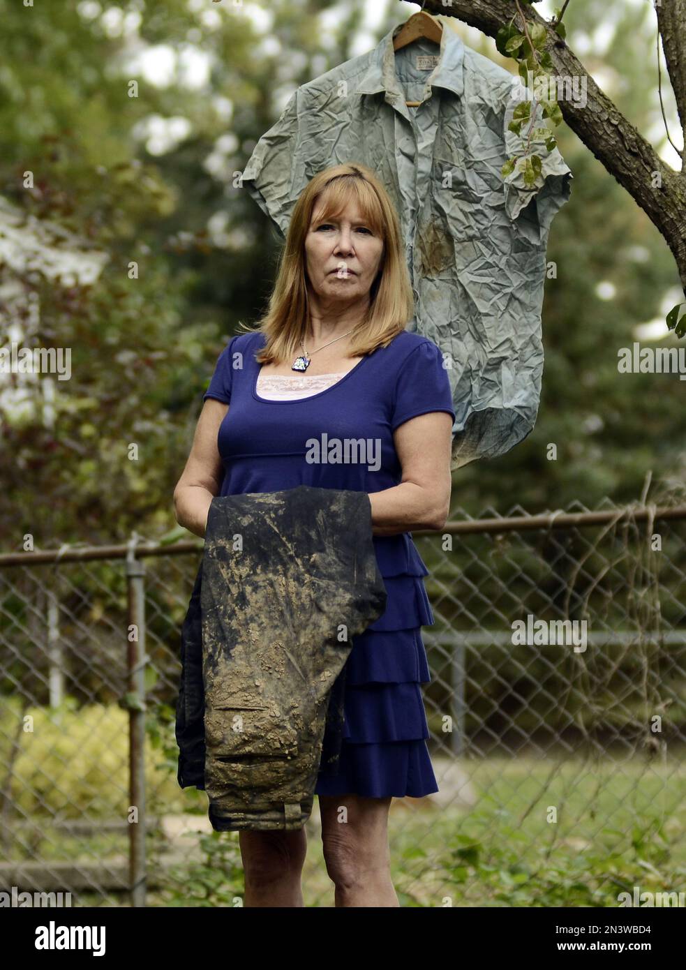 Vickie Smith Menz holds the uniform pants worn by her late father, Art ...