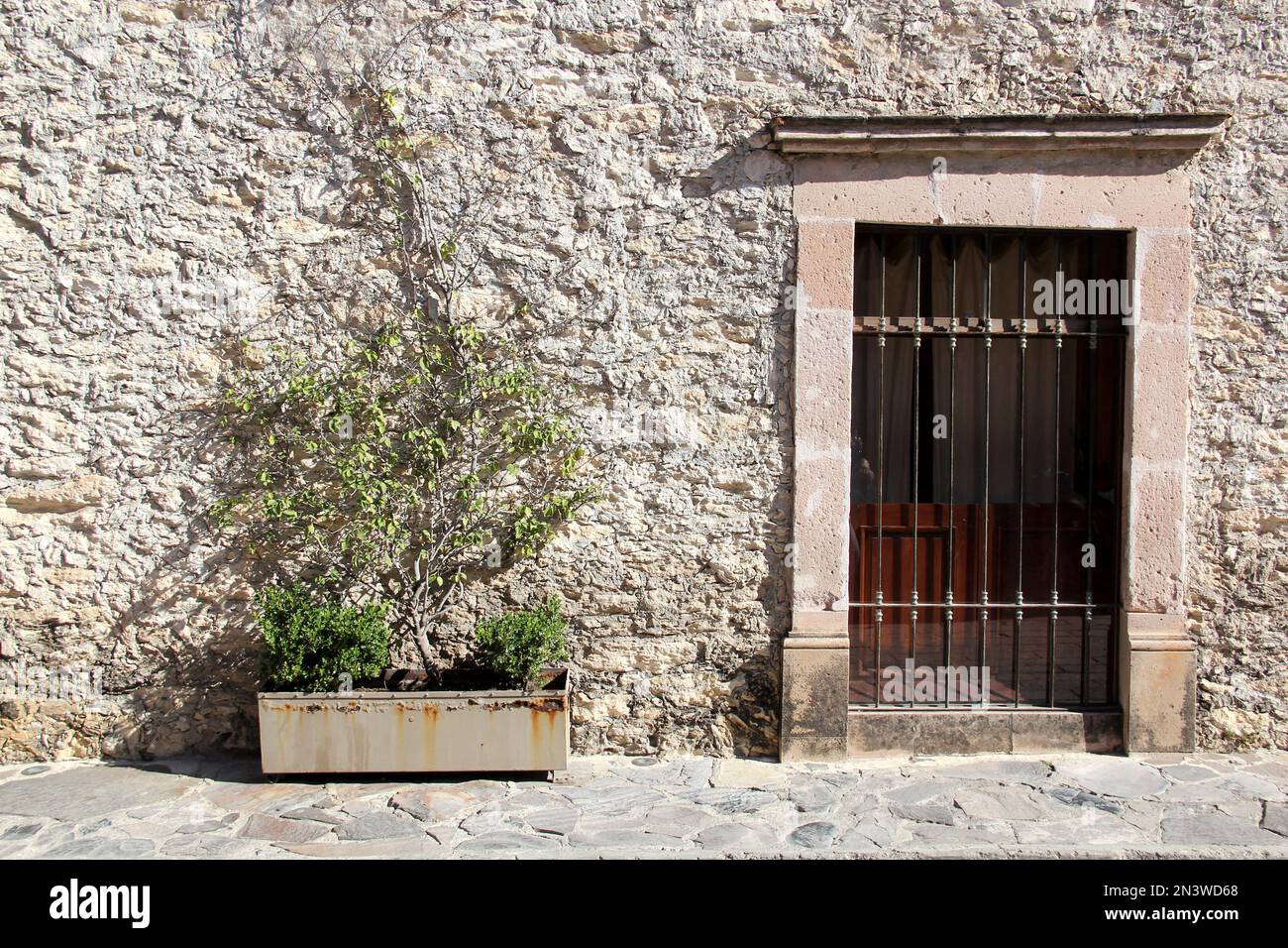Long window facing the street with a colonial style protection grill ...
