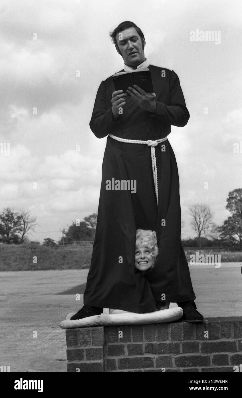 British actor Bernard Bresslaw, dressed as Father Bernard is shown with ...