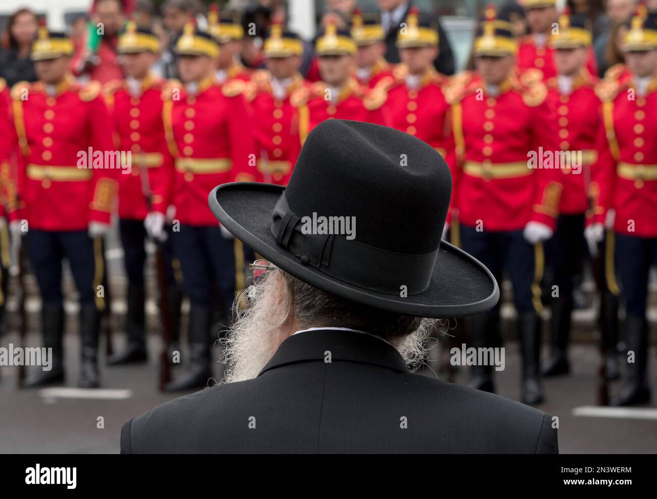 Rabbi Rafael Schaffer stands back dropped by honor guard soldiers ...