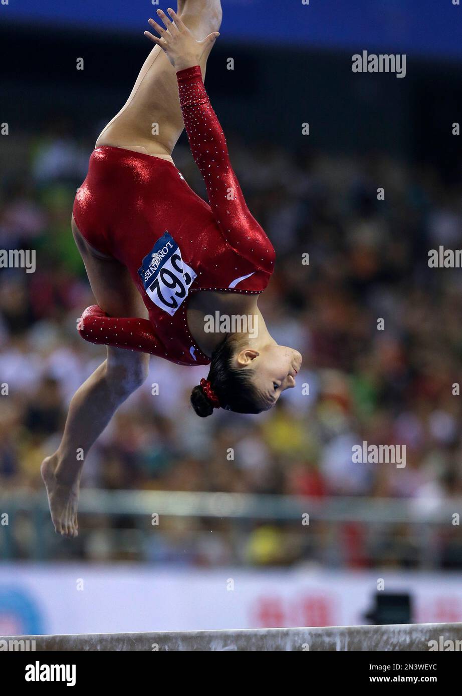 Kyla Ross of the United States keeps her eyes on the balance beam as ...