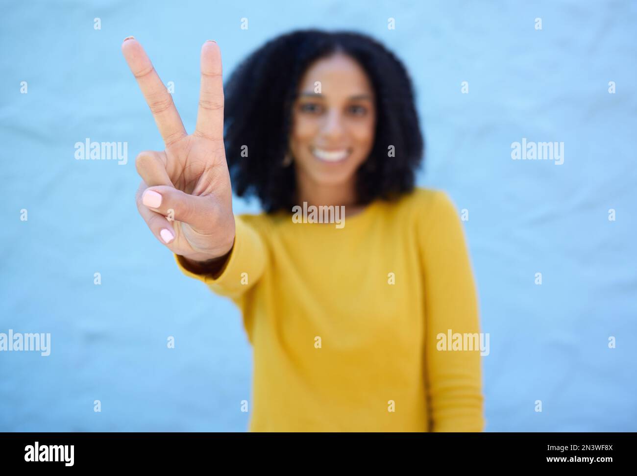 Black woman, hand and peace sign for victory, win or letter V against a ...