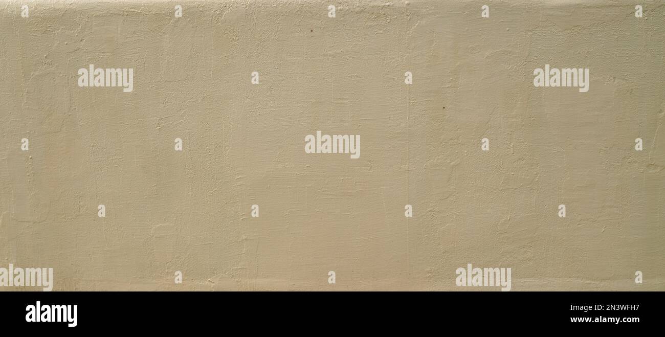 background brown painted beige roughcast wall and trace of spatula ...