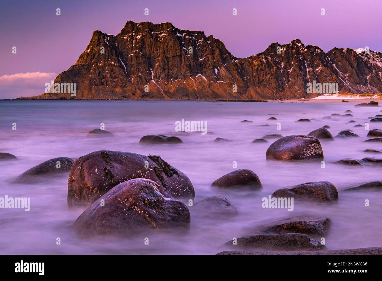 Winter coastal landscape with stormy sea, rocks, long exposure ...