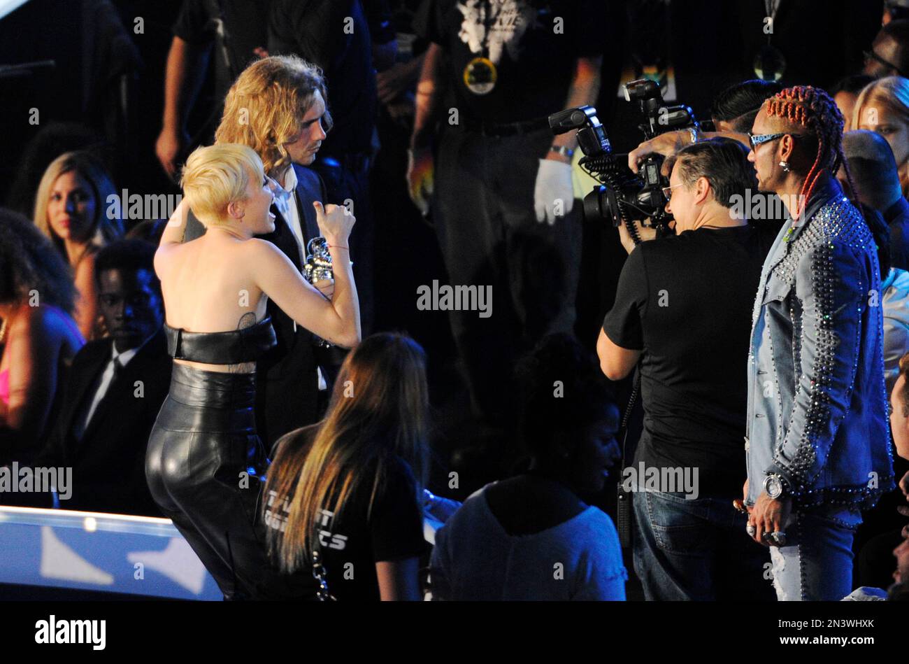 FILE - In this Sunday, Aug. 24, 2014 file photo, Miley Cyrus, left ...