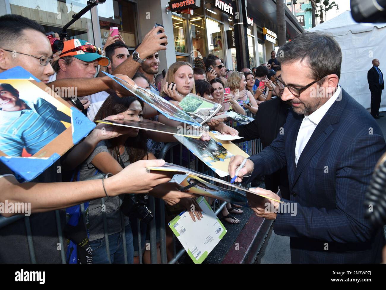 Steve Carell signs autographs at the world premiere of "Alexander And ...