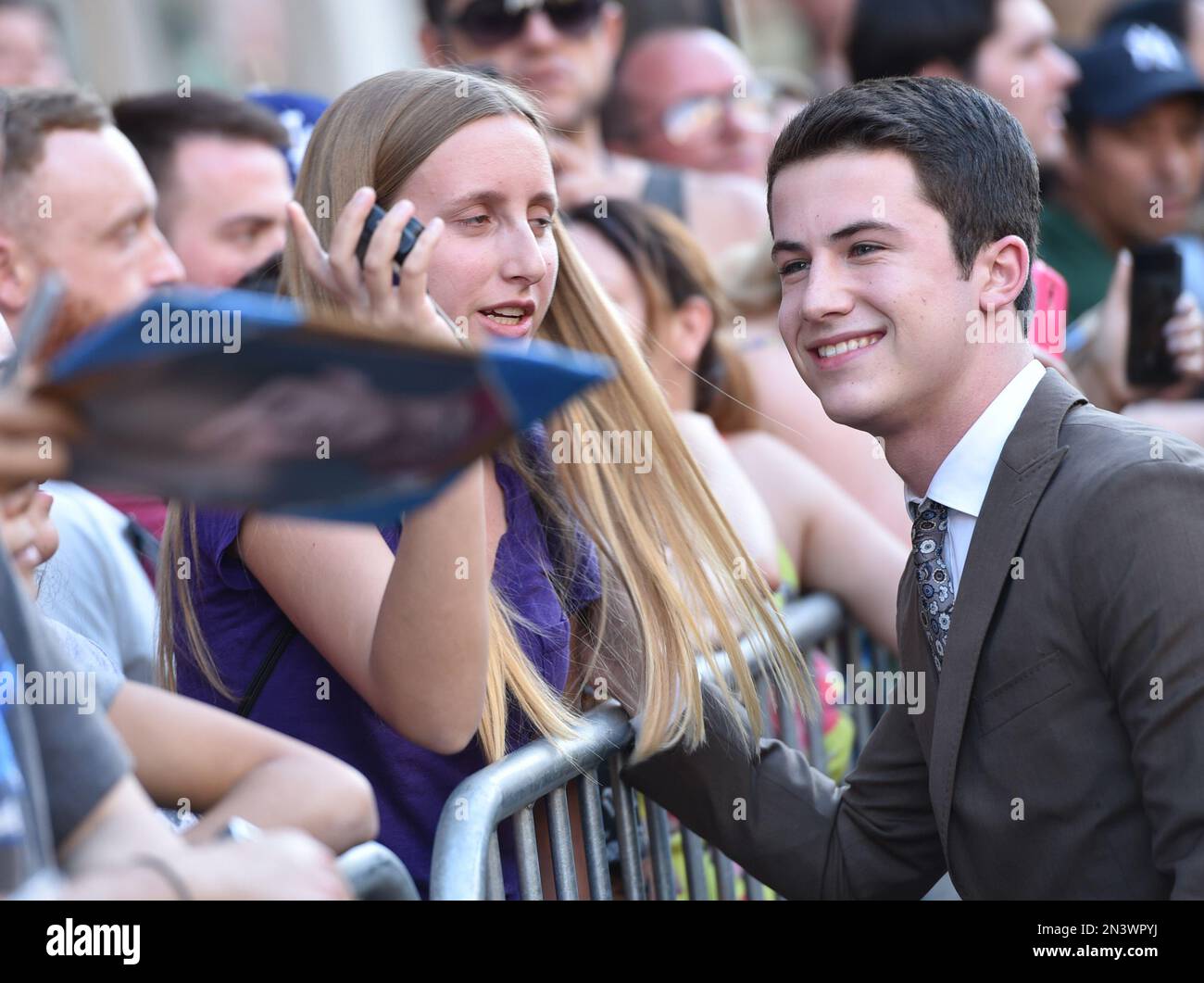 Dylan Minnette poses for a photo with a fan at the world premiere of ...