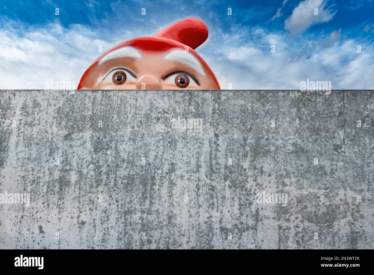 Dwarf peeping over wall Stock Photo - Alamy