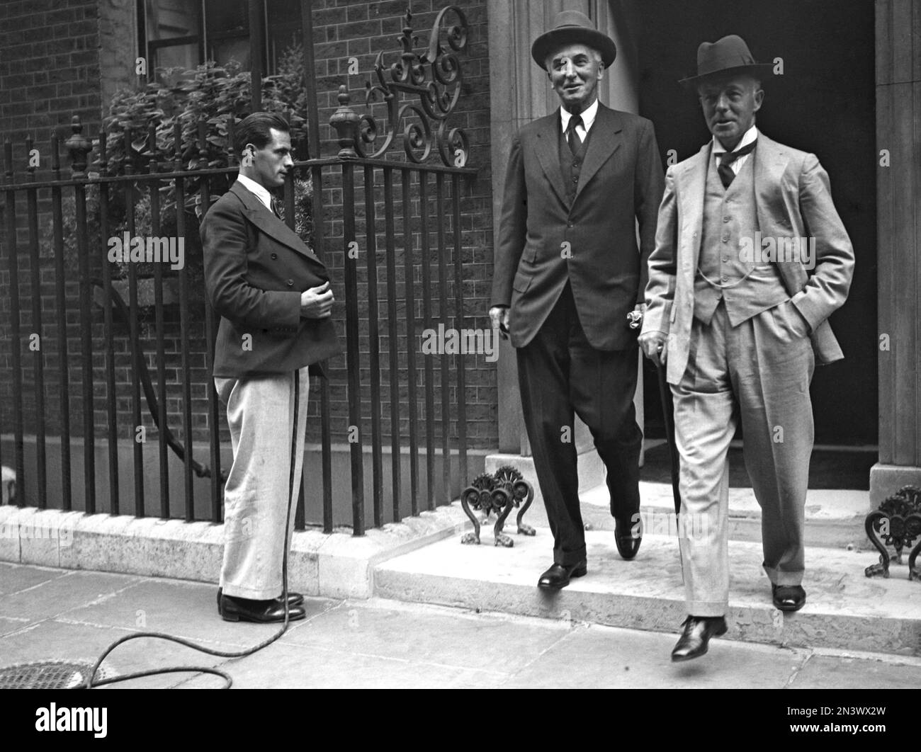 Politicians Sir John Simon, center, and Walter Runciman, right, leave ...