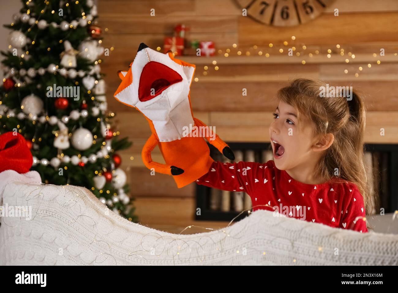 Cute little girl performing puppet show at home Stock Photo - Alamy