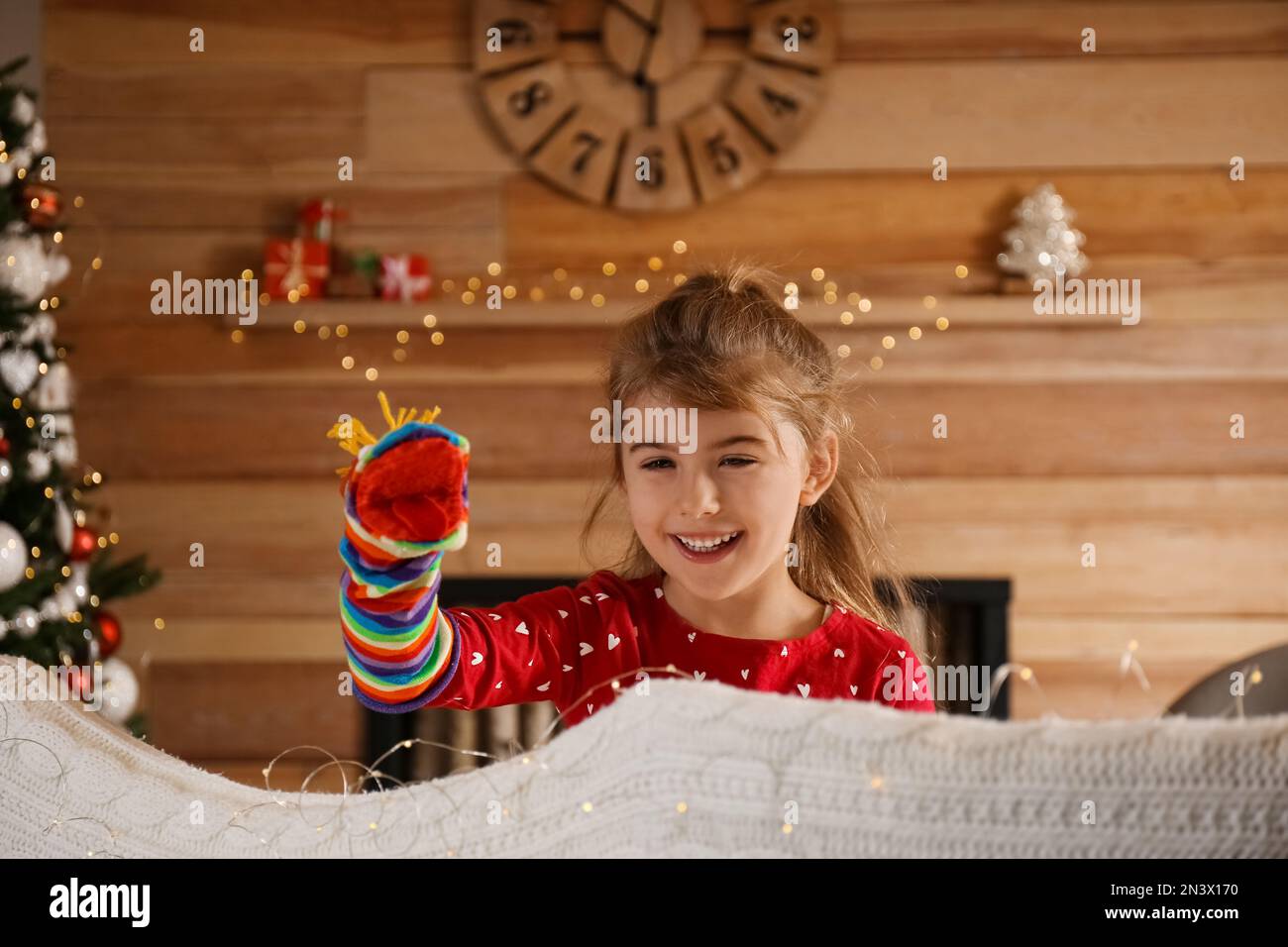 Cute little girl performing puppet show at home Stock Photo - Alamy