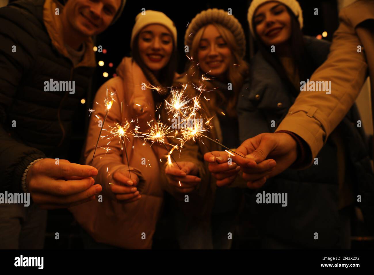 Group of people holding burning sparklers, focus on hands Stock Photo ...