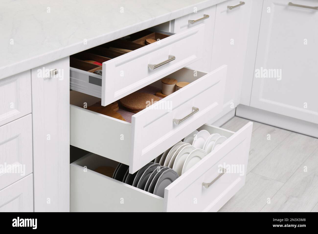 Open drawers with cutlery and utensils indoors. Order in kitchen Stock ...