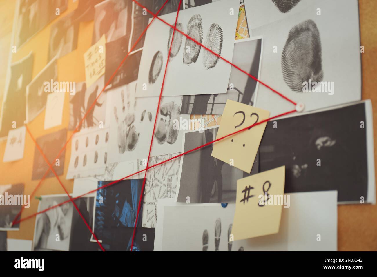 Detective board with crime scene photos, stickers, clues and red thread ...