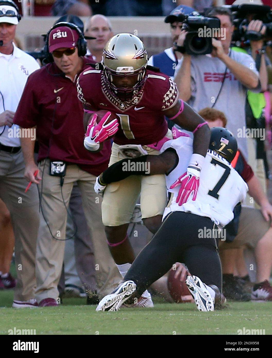 Florida State head coach, Jimbo Fisher, background left, watches Ermon ...