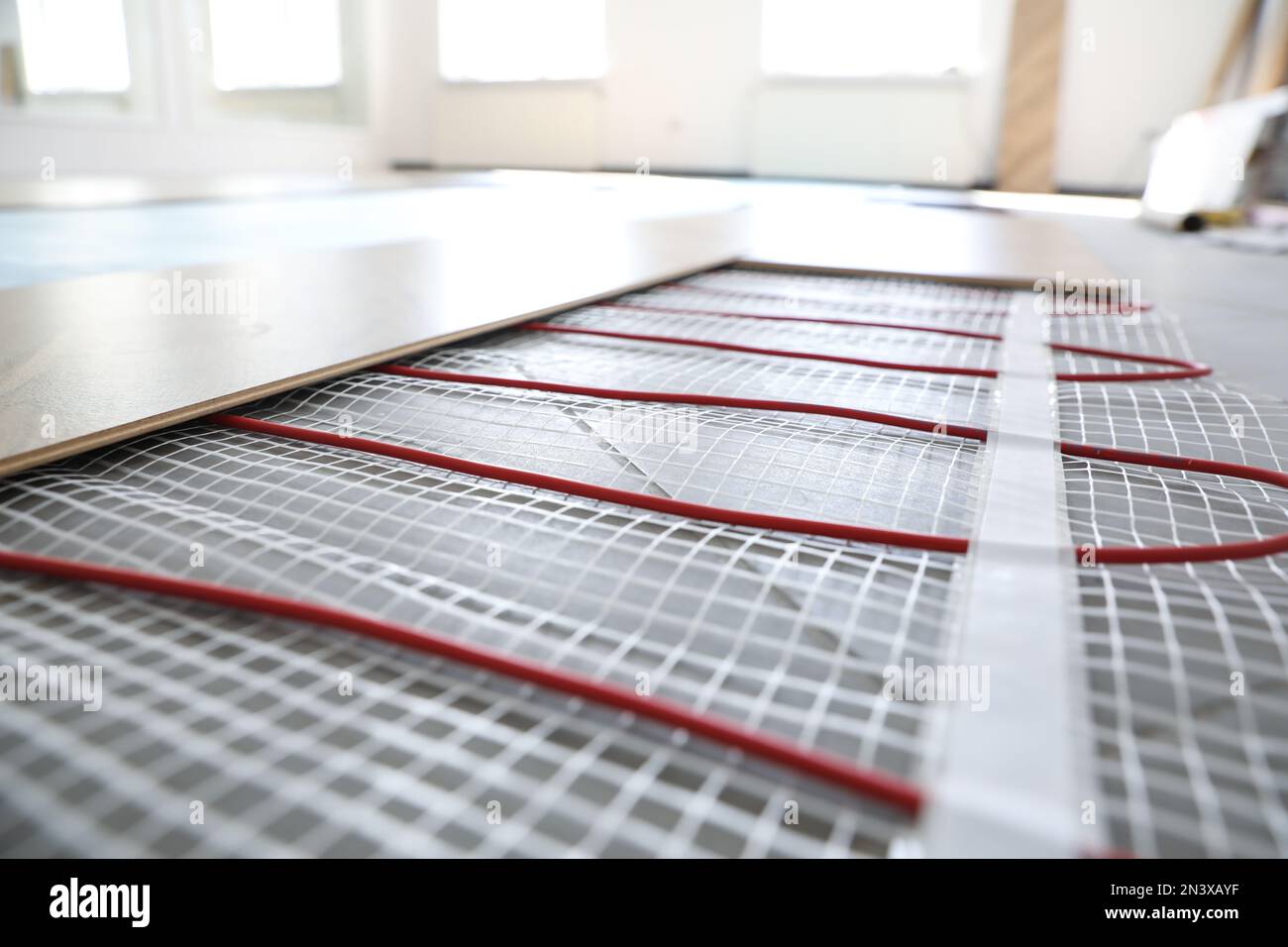 Installation of modern underfloor trace heating system indoors, closeup ...