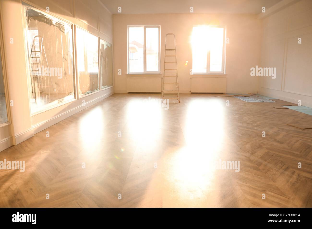 Spacious empty room with new parquet flooring and mirrors Stock Photo ...