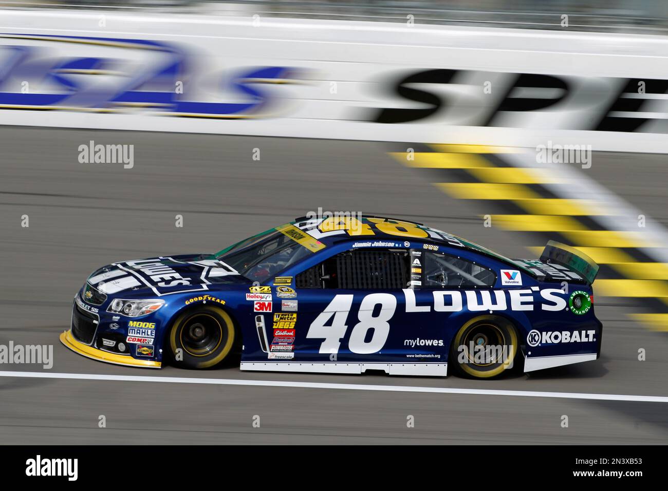 NASCAR Sprint Cup Series driver Jimmie Johnson heads down the track ...