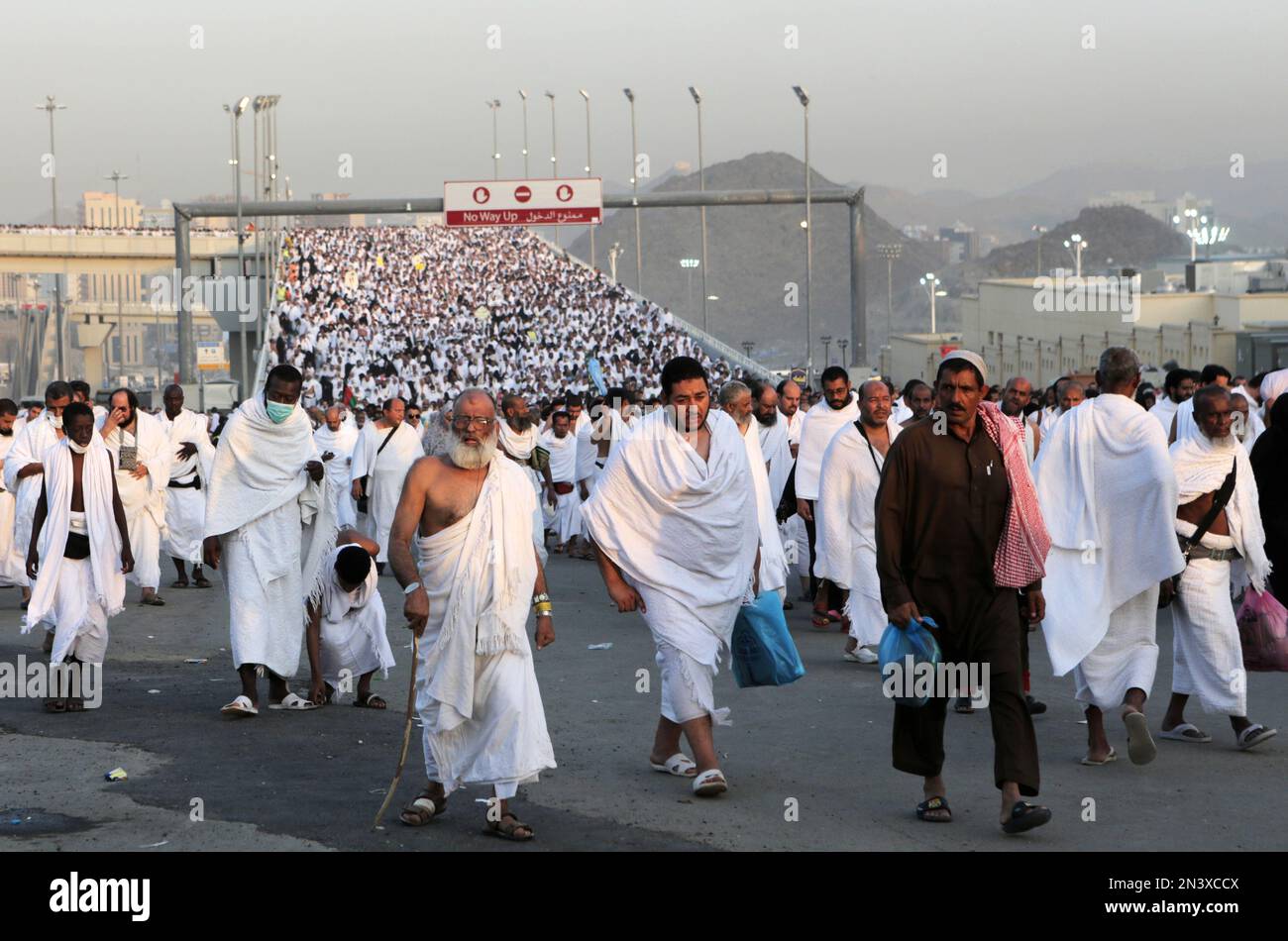 Thousands of Muslim pilgrims make their way to throw stones at a pillar ...