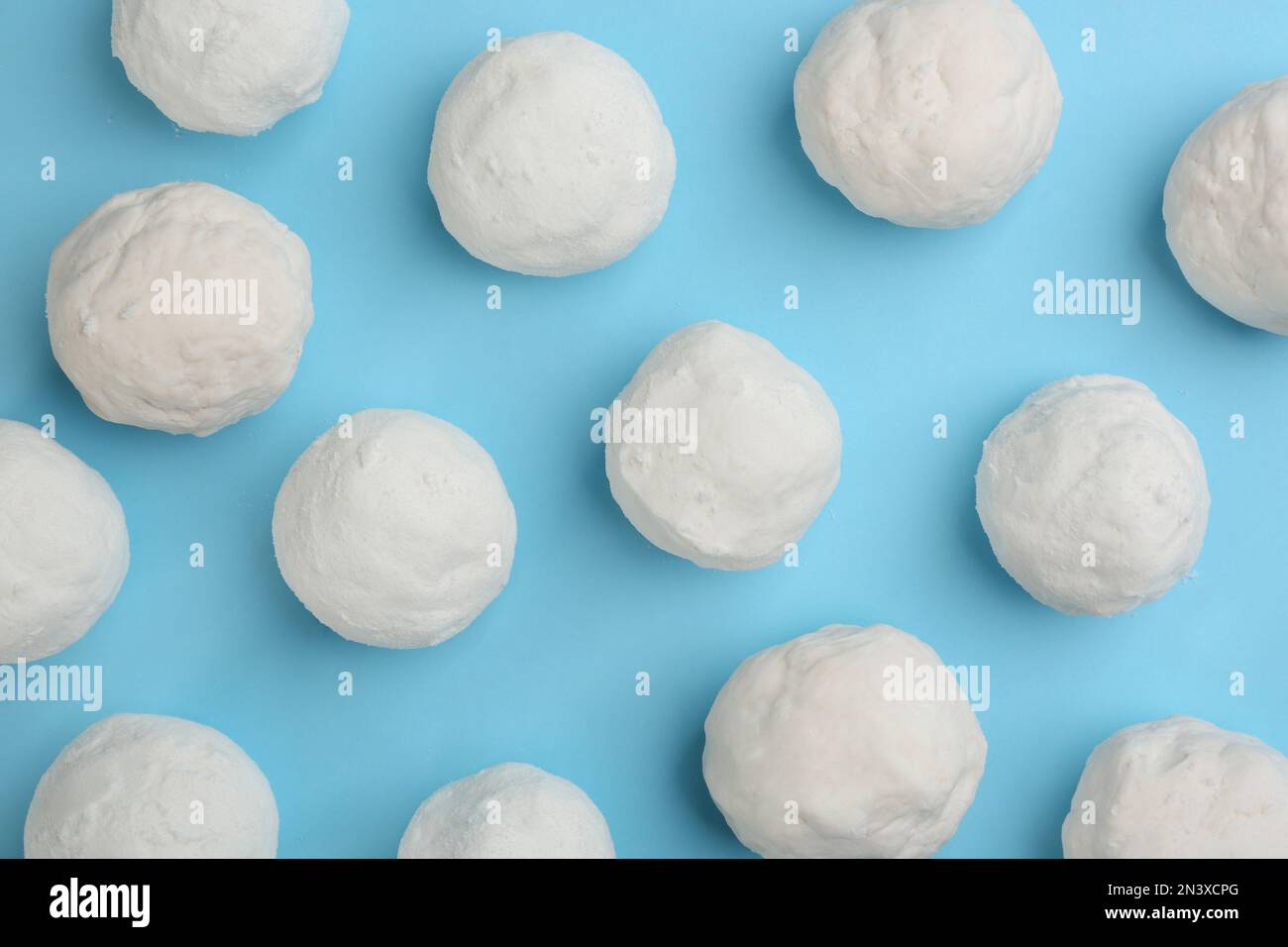 Round snowballs on light blue background, flat lay Stock Photo - Alamy