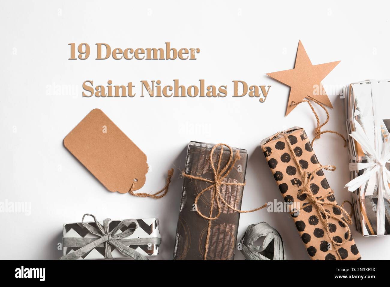 19 December Saint Nicholas Day. Beautiful gift boxes with tags on white ...