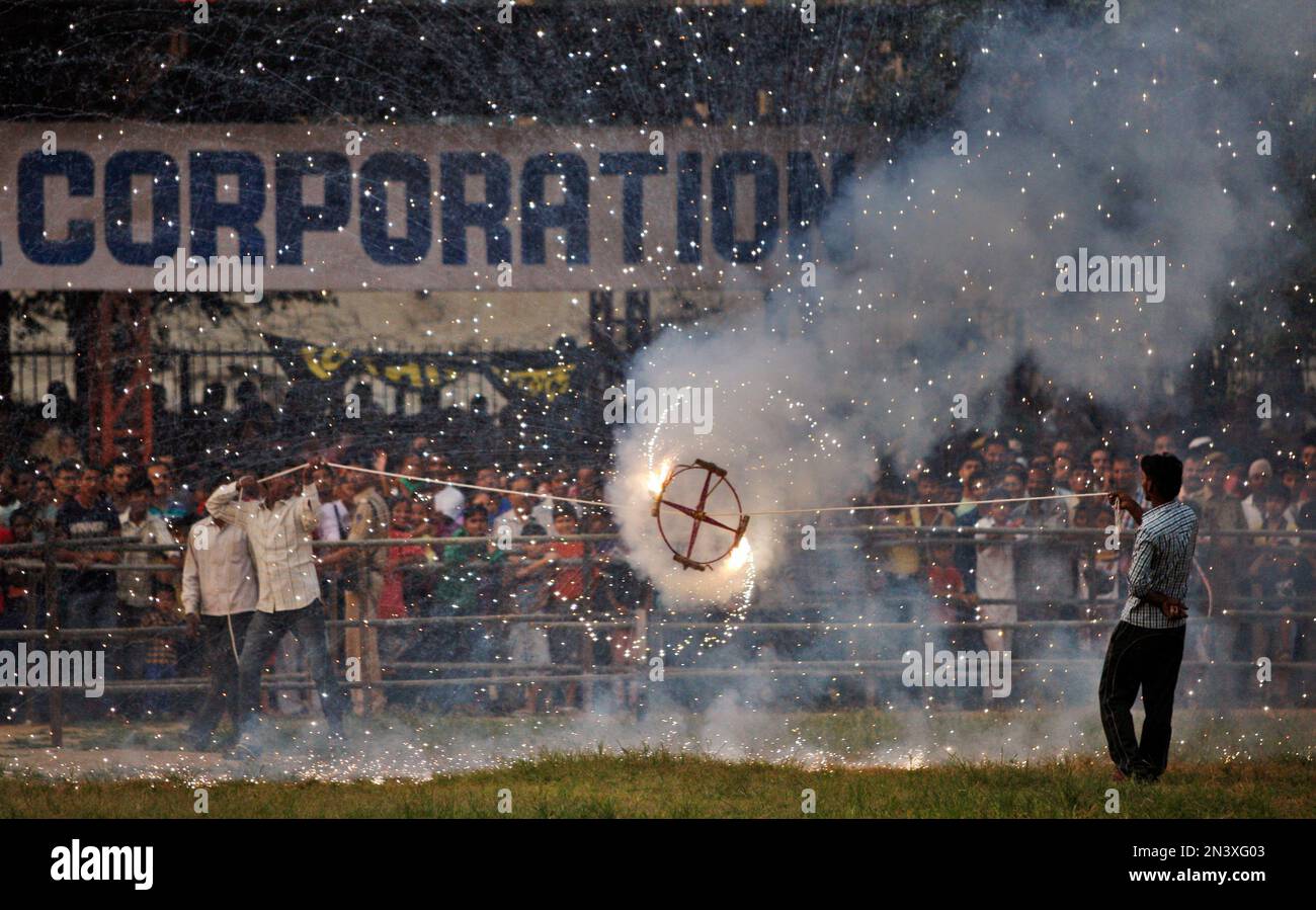 Indian workers burst crackers marking the end of Dussehra festival in ...