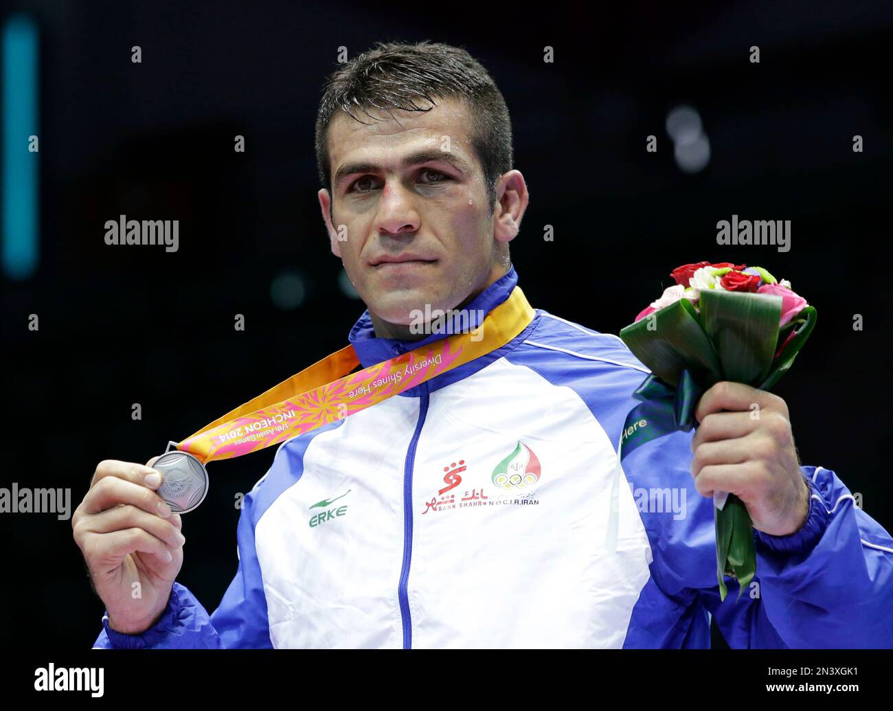 Iran's Jasem Delavari stands on the podium after receiving his silver ...